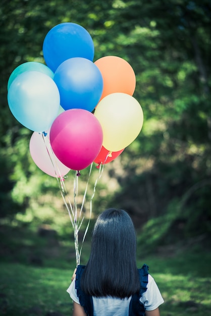 Mano de niña sosteniendo globos de colores | Foto Gratis Mano de niña sosteniendo globos de colores | Foto Gratis