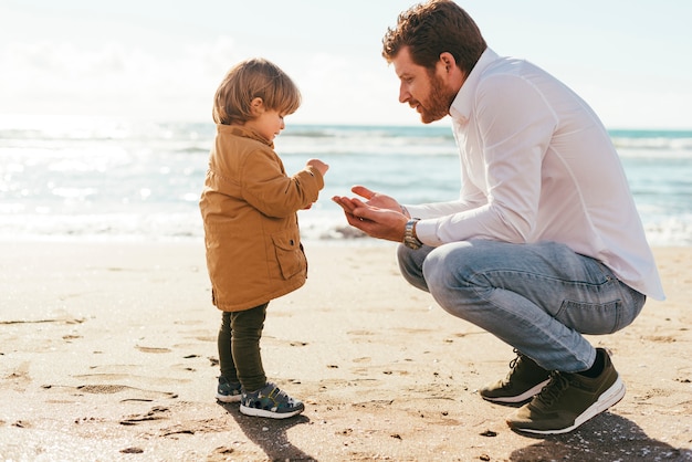 Free Photo | Adorable toddler getting familiar with beach sand Free Photo | Adorable toddler getting familiar with beach sand