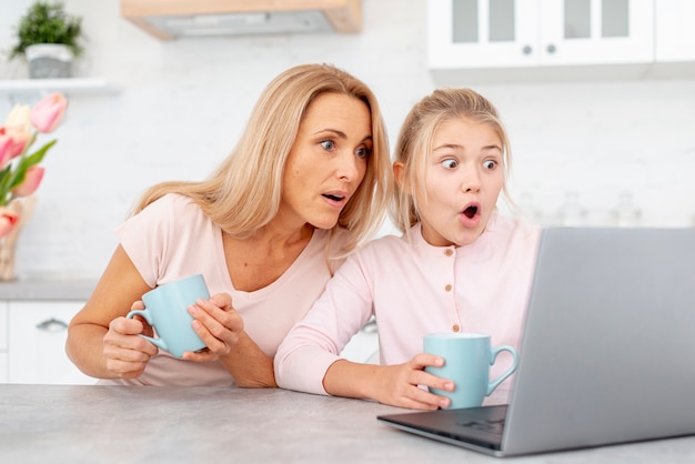 Free Photo Amazed Mother And Daughter Looking On Laptop