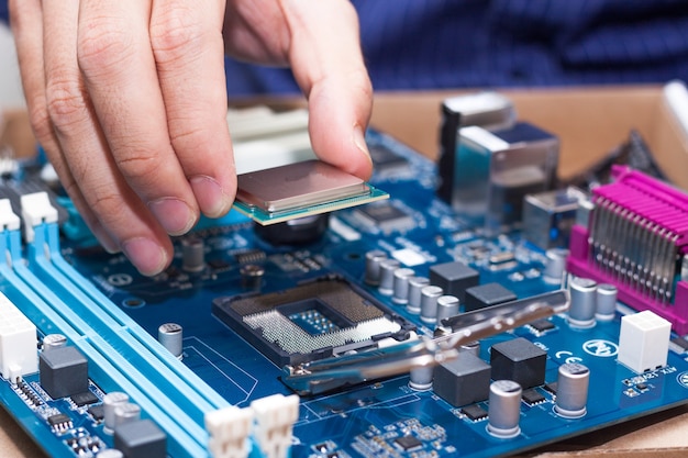 Premium Photo | Assembling high performance personal computer, inserting cpu, processor into the ...