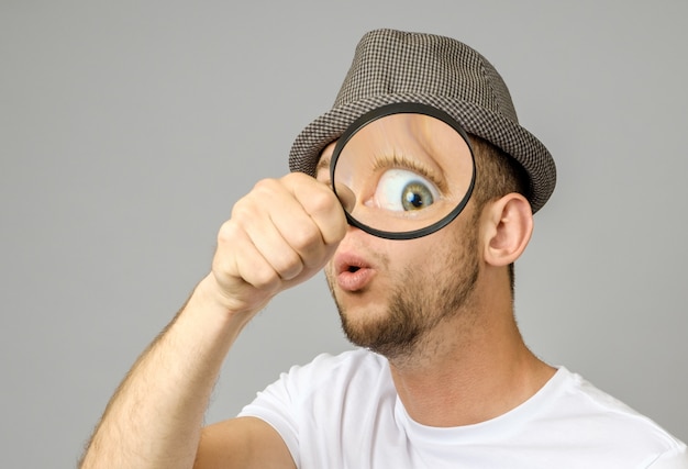 Premium Photo | Astonished man looking through a magnifying glass Premium Photo | Astonished man looking through a magnifying glass