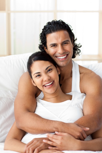 Premium Photo Attractive Man Hugging His Wife Lying On The Bed