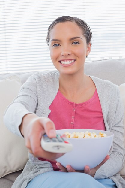 Premium Photo Attractive Woman Eating Popcorn While Watching Tv