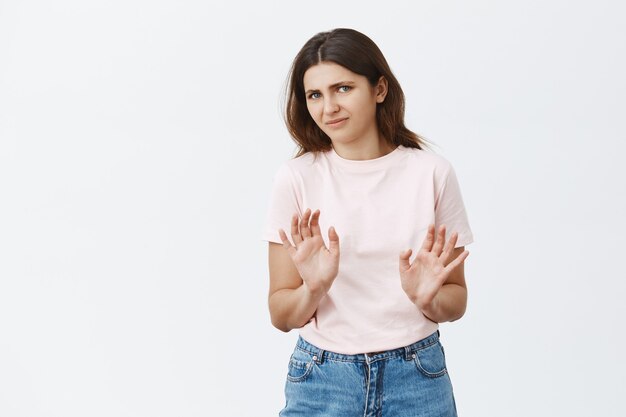 Free Photo Awkward And Displeased Young Brunette Posing