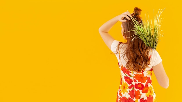 Free Photo | Back view woman holding plants Free Photo | Back view woman holding plants