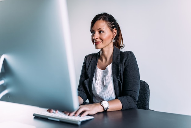Premium Photo | Beautiful female administrator working on a computer. Premium Photo | Beautiful female administrator working on a computer.