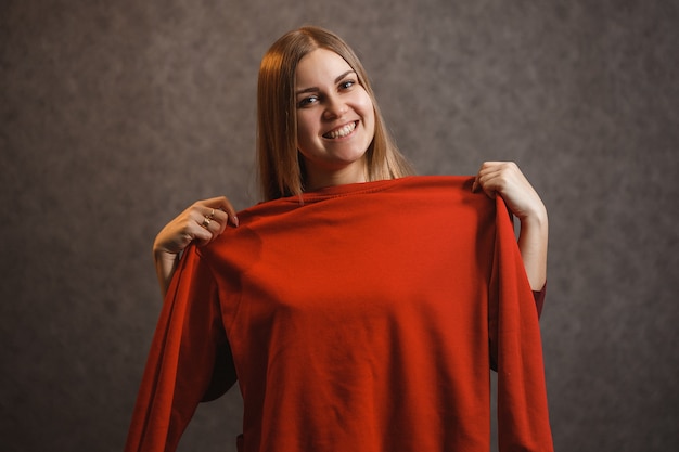 Premium Photo Beautiful Girl Tries On A Red Sweater