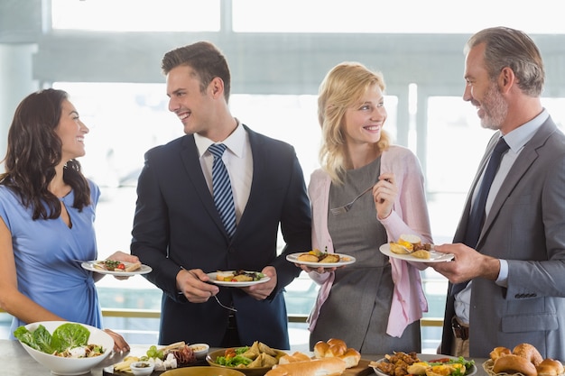Premium Photo | Business colleagues interacting while serving ... Premium Photo | Business colleagues interacting while serving ...