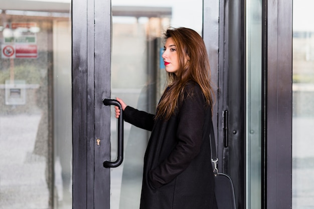 Business woman in black entering building Photo | Free Download Business woman in black entering building Photo | Free Download