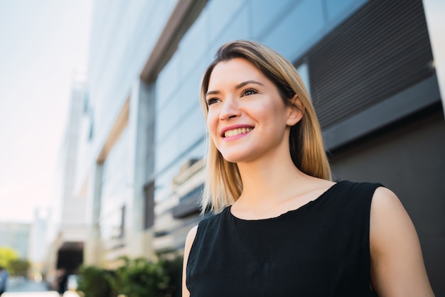Premium Photo | Business woman standing outside office buildings. Premium Photo | Business woman standing outside office buildings.