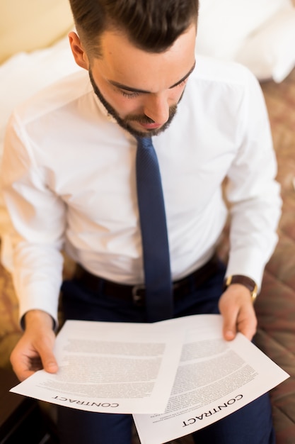 Premium Photo | Businessman reading documents in bedroom Premium Photo | Businessman reading documents in bedroom