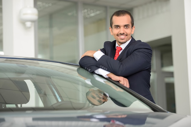 Premium Photo | Businessman in a tie and suit stands and smiles. Premium Photo | Businessman in a tie and suit stands and smiles.