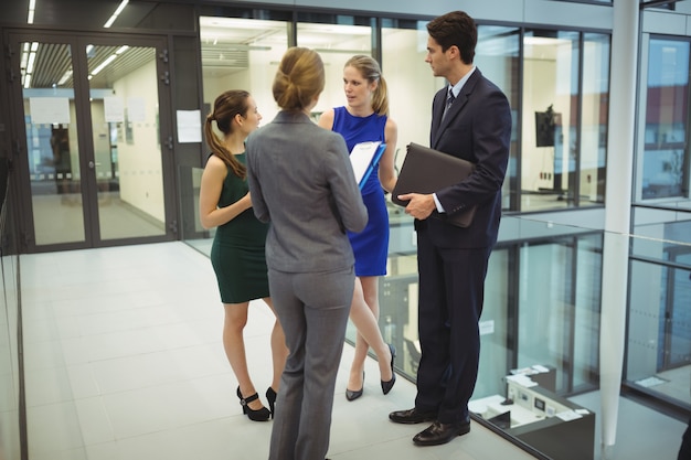 Premium Photo | Businesspeople having a discussion in the corridor Premium Photo | Businesspeople having a discussion in the corridor