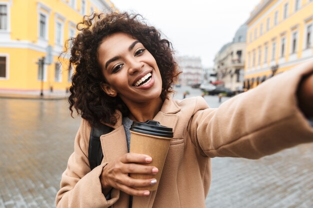 Premium Photo Cheerful Young African Woman Wearing Coat Walking