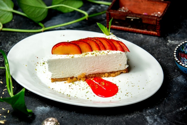 Free Photo Cheesecake Slice Garnished With Plum Slices And Syrup