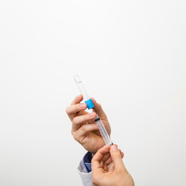 Premium Photo | Close-up hands holding a syringe Premium Photo | Close-up hands holding a syringe