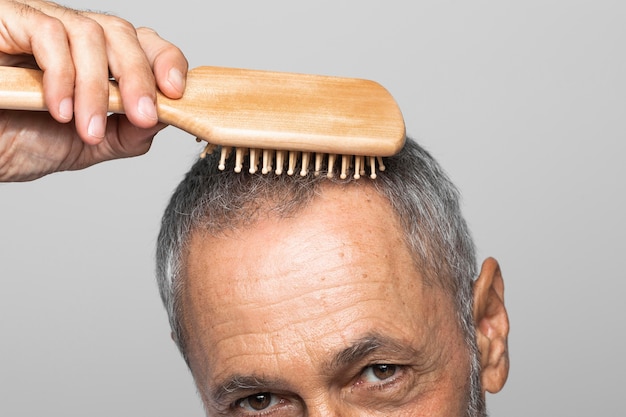 Free Photo | Close-up senior man brushing hair Free Photo | Close-up senior man brushing hair