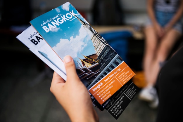Premium Photo | Closeup of hand holding bangkok travel guide brochure Premium Photo | Closeup of hand holding bangkok travel guide brochure