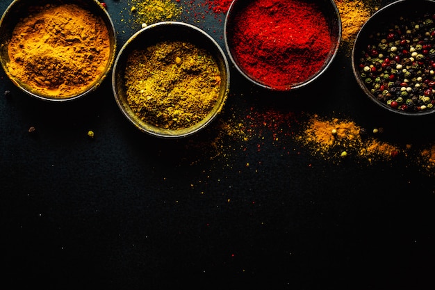 Premium Photo | Colorful spices on dark surface Premium Photo | Colorful spices on dark surface