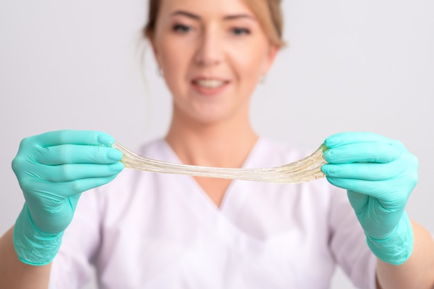 Premium Photo | Cosmetologist holds sugar paste. Premium Photo | Cosmetologist holds sugar paste.
