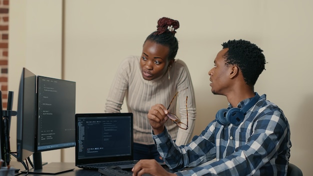 Premium Photo | Database developer removing glasses while explaining algorithm to colleague ...