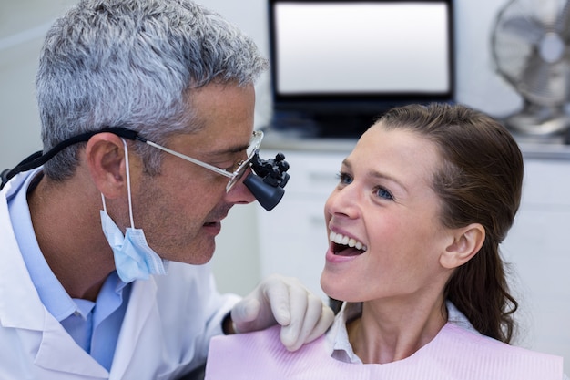 Premium Photo | Dentist examining a female patient with dental loupes Premium Photo | Dentist examining a female patient with dental loupes