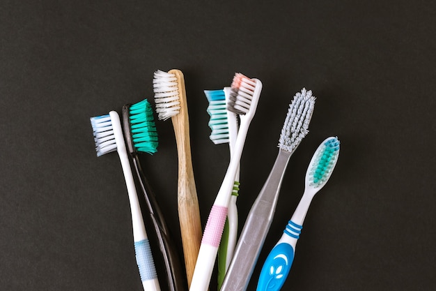 Premium Photo | Different types of toothbrushes on a black background Premium Photo | Different types of toothbrushes on a black background