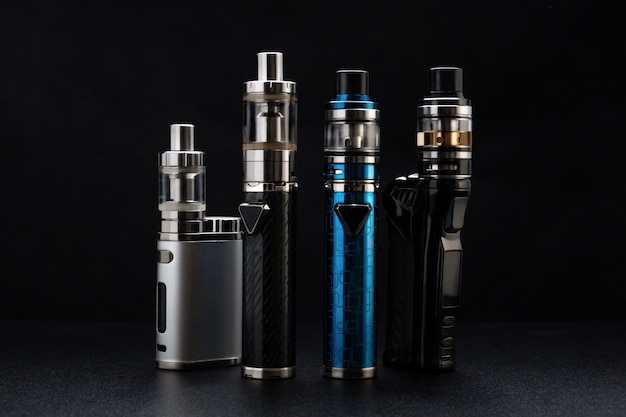 Premium Photo Different Types Of Vaping Devices On Black Background