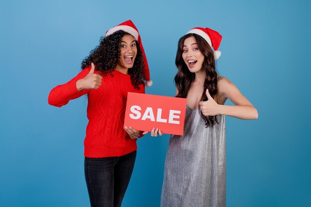 Premium Photo Diverse Women Wearing Santa Hats With Red Sale Sign