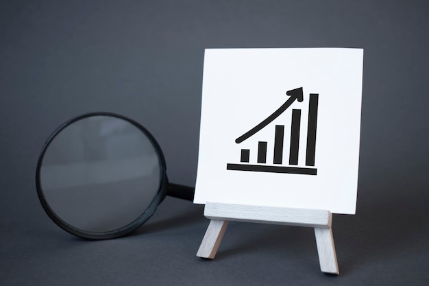Premium Photo | Easel,magnifier and up arrow chart. concept of success ... Premium Photo | Easel,magnifier and up arrow chart. concept of success ...