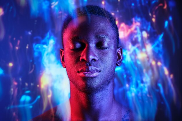Premium Photo Emotionless Black Man With Eyes Closed Standing In Blurred Lights