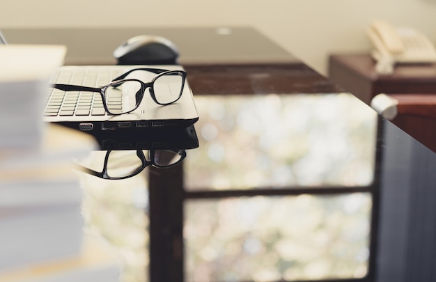 Premium Photo Eye Glasses On Work Desk With Chart And Laptop At Business Workplace