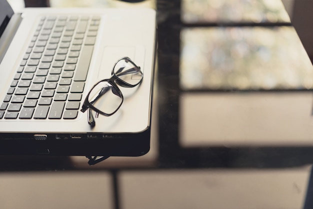 Premium Photo Eye Glasses On Work Desk With Chart And Laptop At Business Workplace
