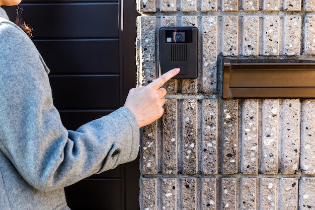 Premium Photo | Female hand pushing the doorbell buzzer Premium Photo | Female hand pushing the doorbell buzzer