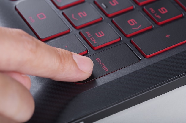 Premium Photo | Finger pushing enter button on laptop keyboard Premium Photo | Finger pushing enter button on laptop keyboard