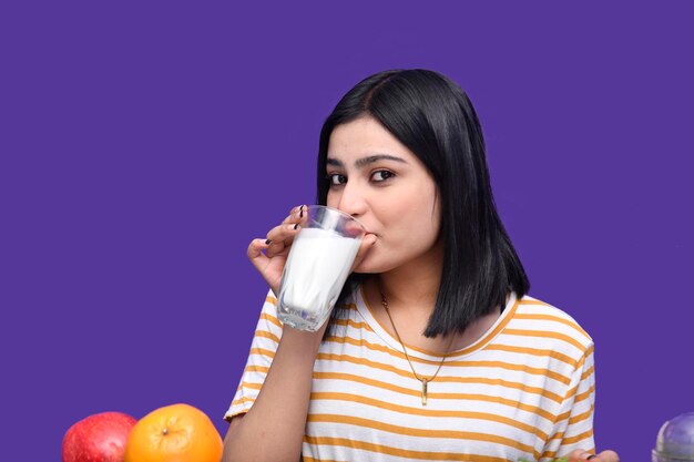 Premium Photo Foodie Girl Sitting At Fruit Table Drinking Milk Over
