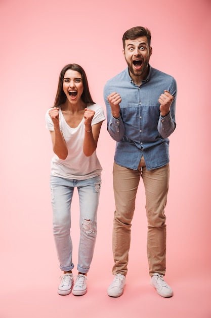 Premium Photo | Full length portrait of an excited young couple screaming Premium Photo | Full length portrait of an excited young couple screaming