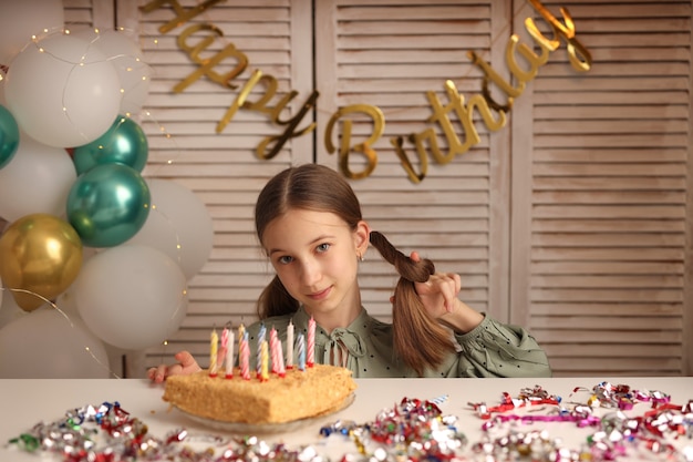 Premium Photo A Girl Blows Out Candles On A Birthday Cake