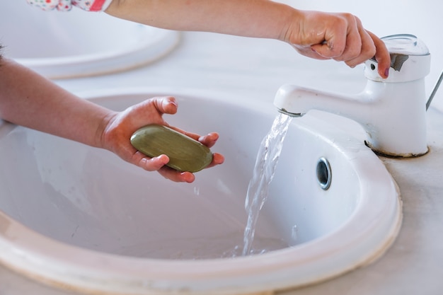 Free Photo | Girl holding soap while washing hand in washbasin Free Photo | Girl holding soap while washing hand in washbasin