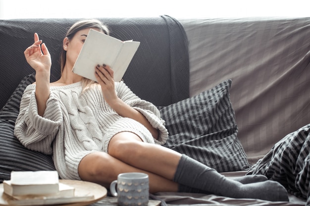 Premium Photo Girl Reading Book On Sofa