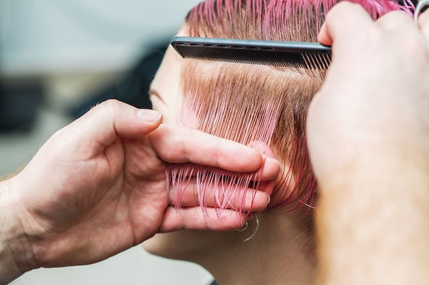 Premium Photo Hairdresser Combs Girls Hair While Cutting