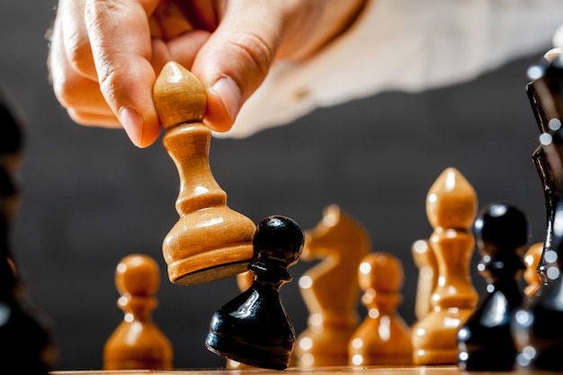Premium Photo | Hand of businessman playing chess Premium Photo | Hand of businessman playing chess