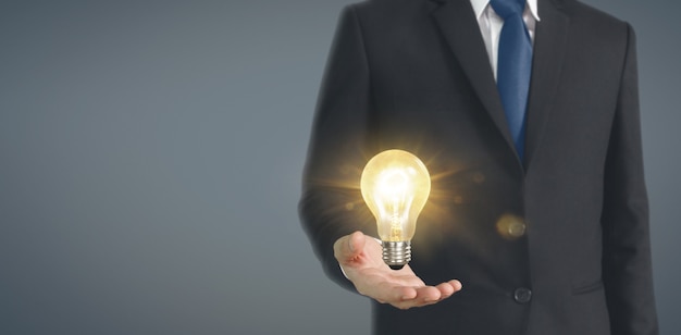 Premium Photo | Hand of holding illuminated light bulb Premium Photo | Hand of holding illuminated light bulb