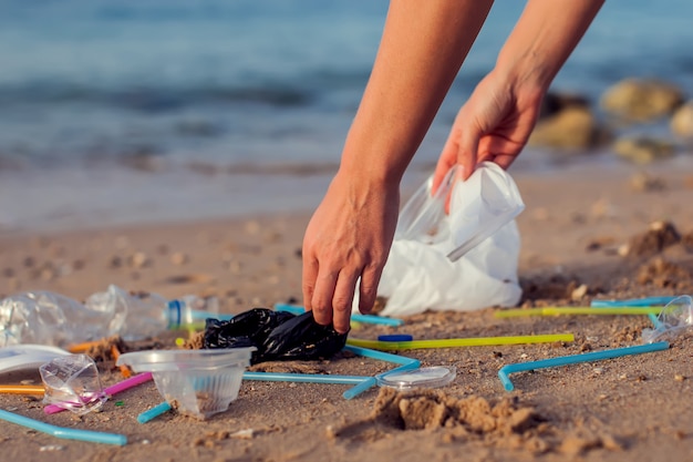 Premium Photo | Hand woman picking up plastic bottle cleaning on the ... Premium Photo | Hand woman picking up plastic bottle cleaning on the ...