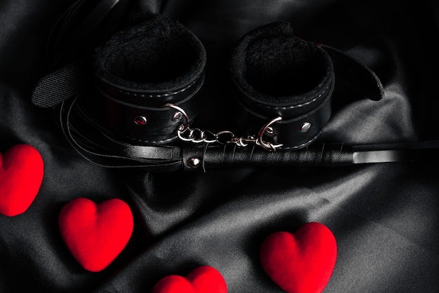 Premium Photo Handcuffs And Whip For Bdsm Sex With Red Hearts