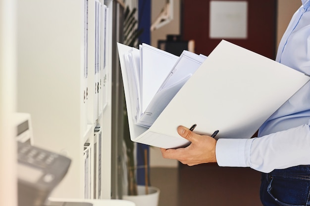 Premium Photo | Hands of a man holding folder with documents Premium Photo | Hands of a man holding folder with documents