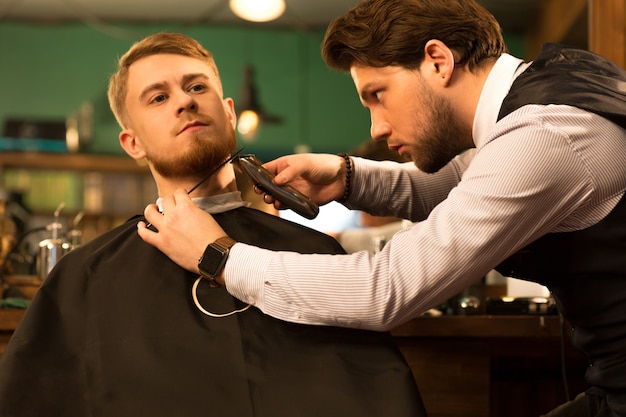 Premium Photo | Handsome young bearded man at the barbershop Premium Photo | Handsome young bearded man at the barbershop