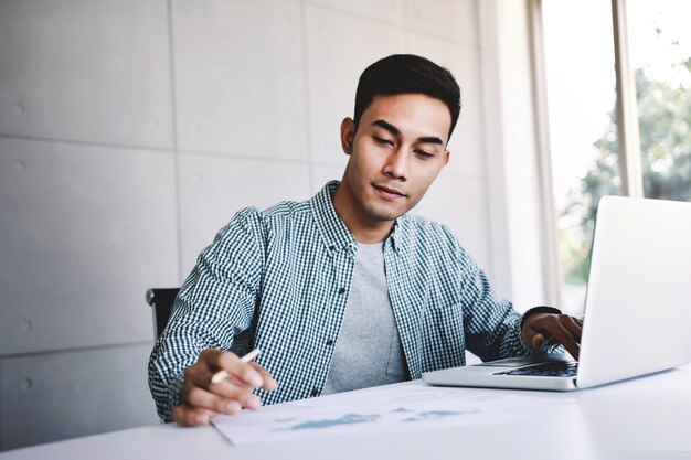 Premium Photo | Happy young asian businessman working on computer ... Premium Photo | Happy young asian businessman working on computer ...