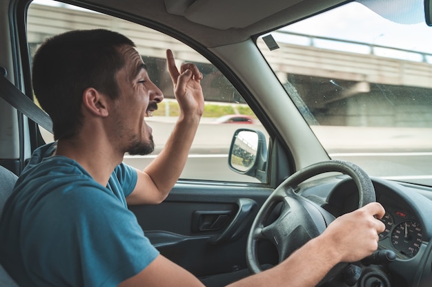 Premium Photo Happy Young Man Driving A Car Dancing And Singing Fun
