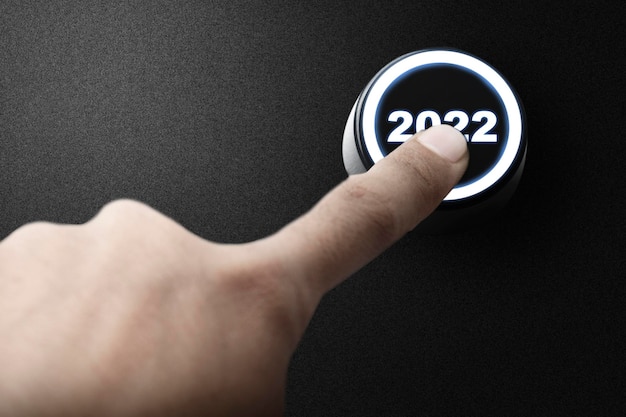 Premium Photo | A human hand pushes the 2022 button. happy new year 2022 Premium Photo | A human hand pushes the 2022 button. happy new year 2022